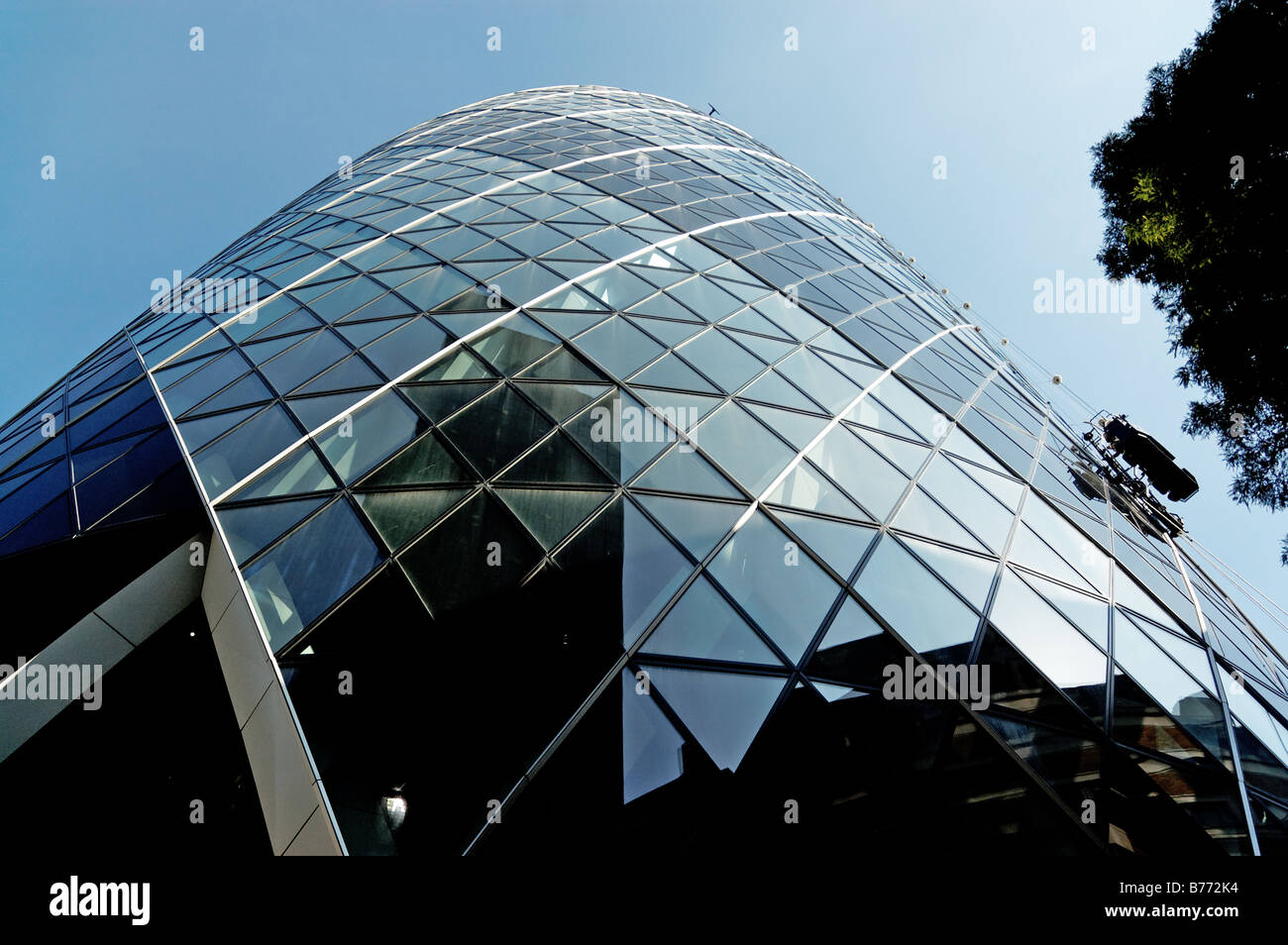 Men in a cage cleaning the windows of The Gherkin in London Stock Photo ...