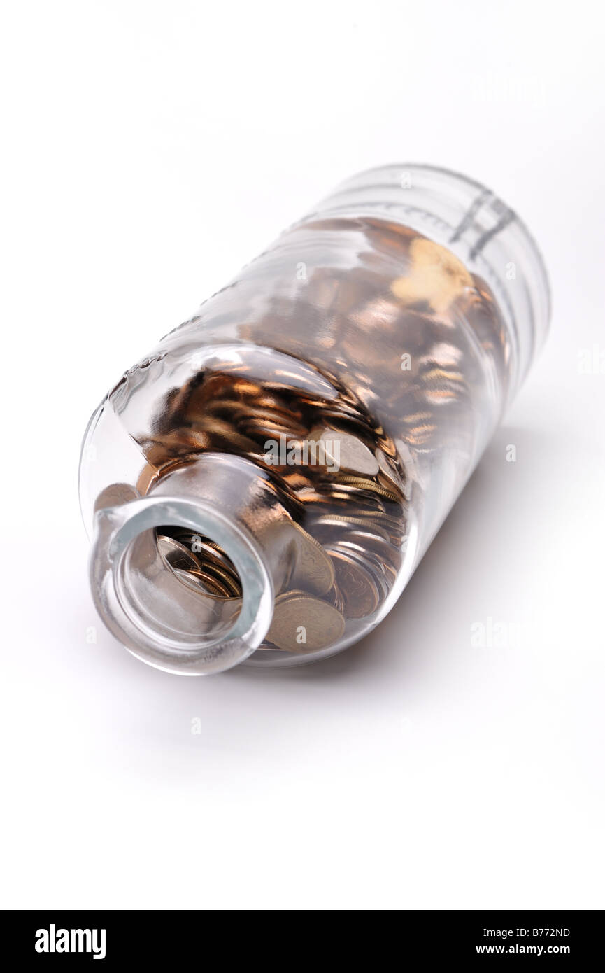 Glass bottle full of coins on a white background Stock Photo - Alamy