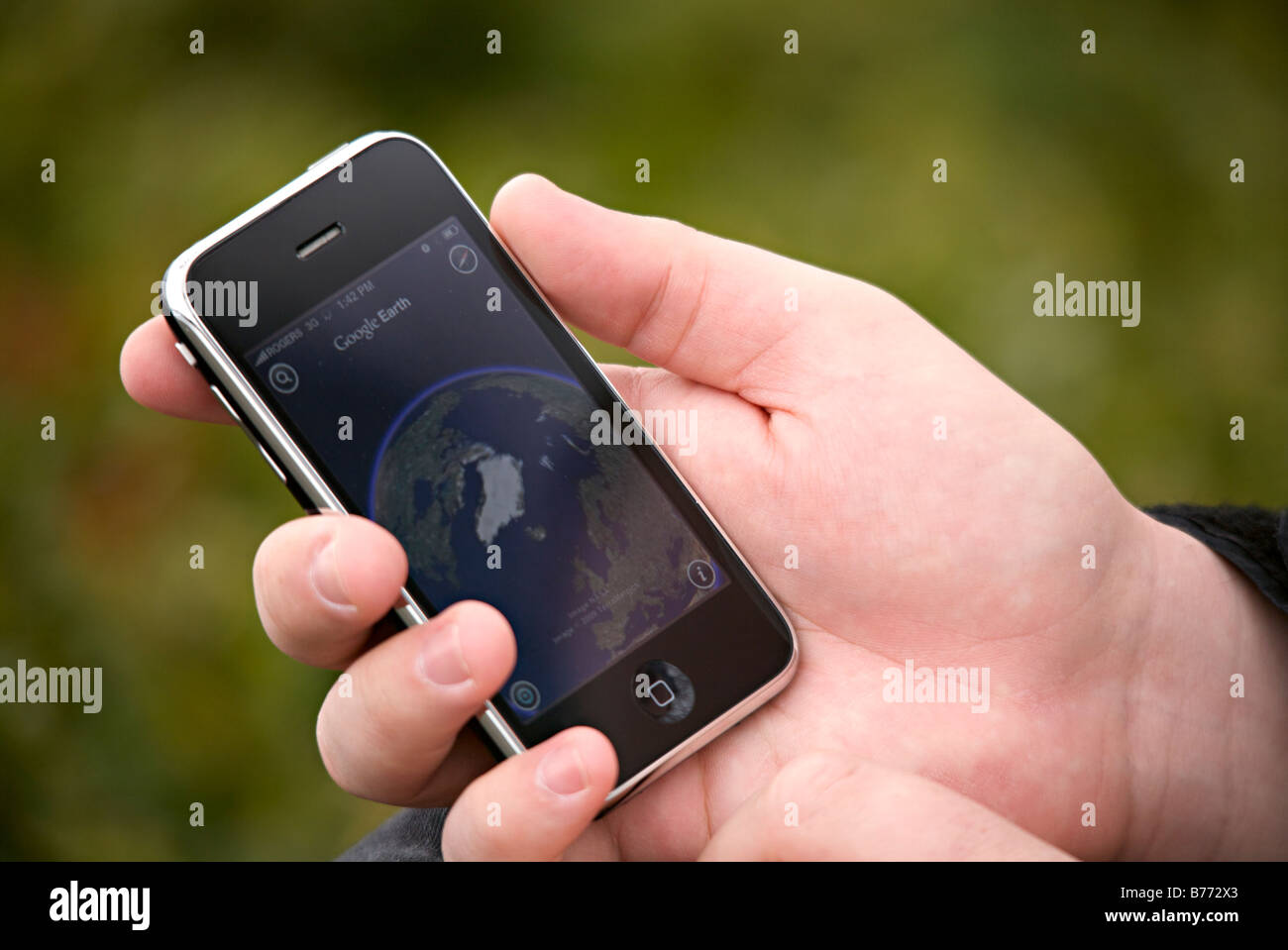 Man hand holding iPhone showing iPhone application Stock Photo - Alamy