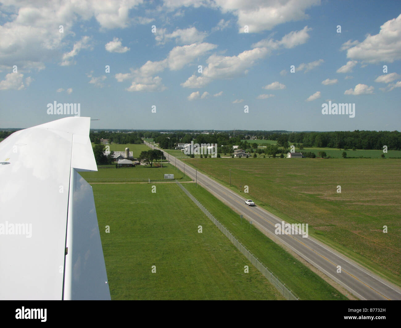 Small airplane airplane approaching runway with flaps Stock Photo - Alamy