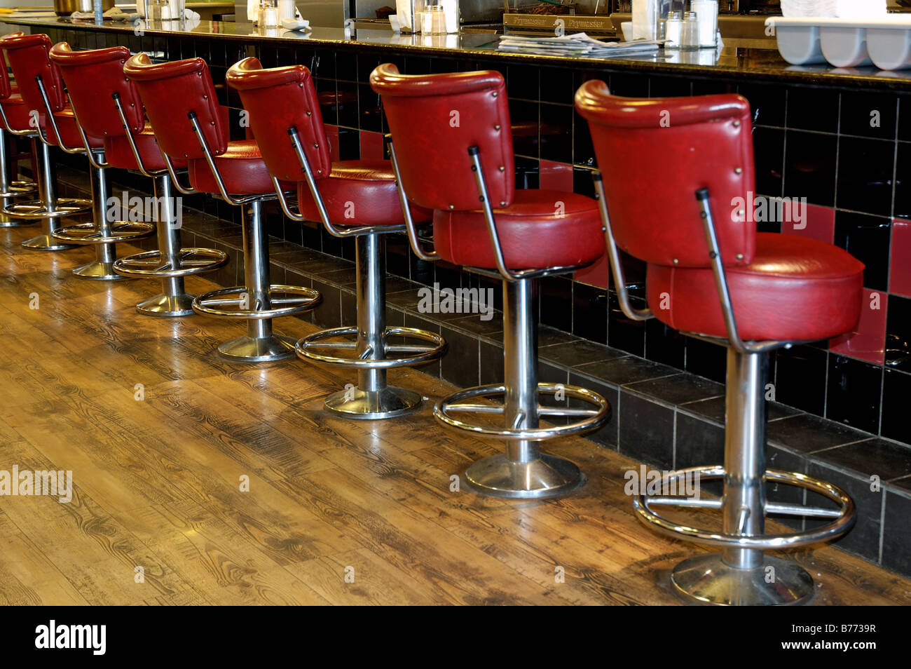 A row of red leather seats in a diner Stock Photo - Alamy
