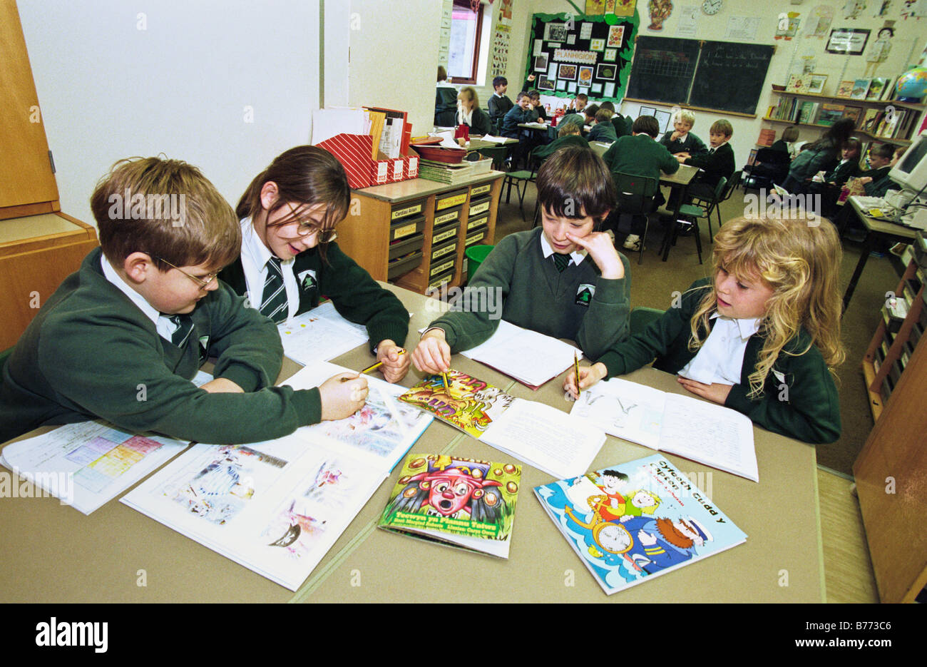Pupils reading Welsh language books in Rhondda Valley primary school ...