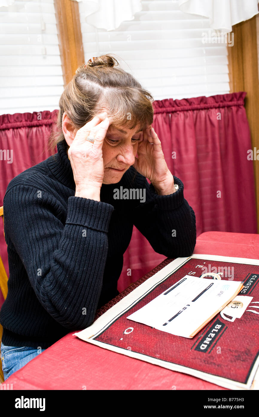 An upset woman unable to pay her bills Stock Photo - Alamy