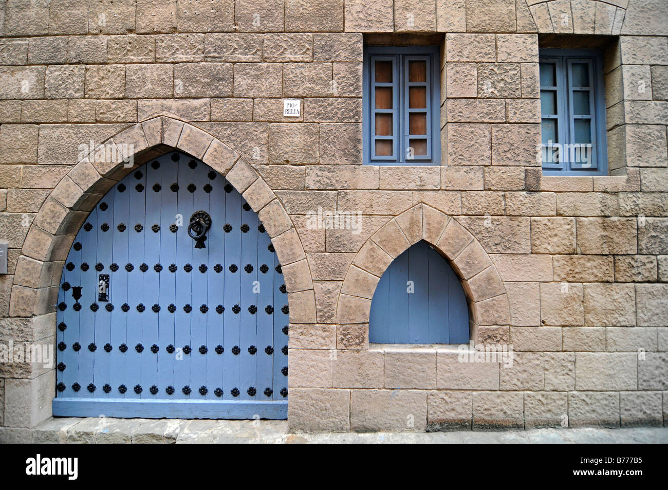 Blue door and windows on a facade, Poble Espanyol, Spanish village ...