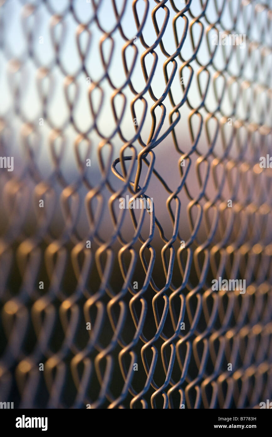 Abstract damaged chain link fence with bent links Stock Photo - Alamy