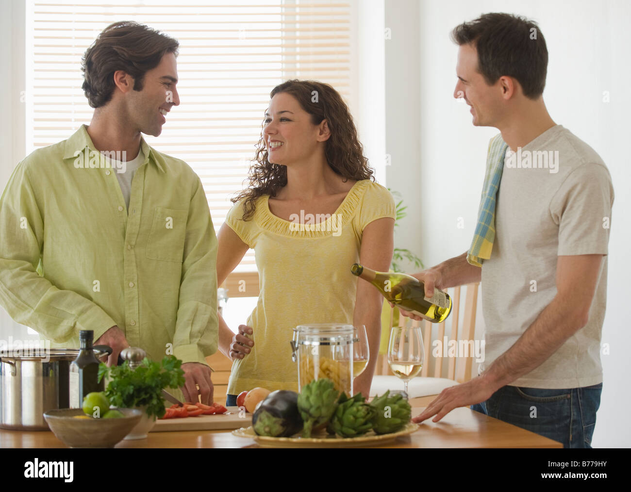 Friends preparing meal kitchen Stock Photo - Alamy