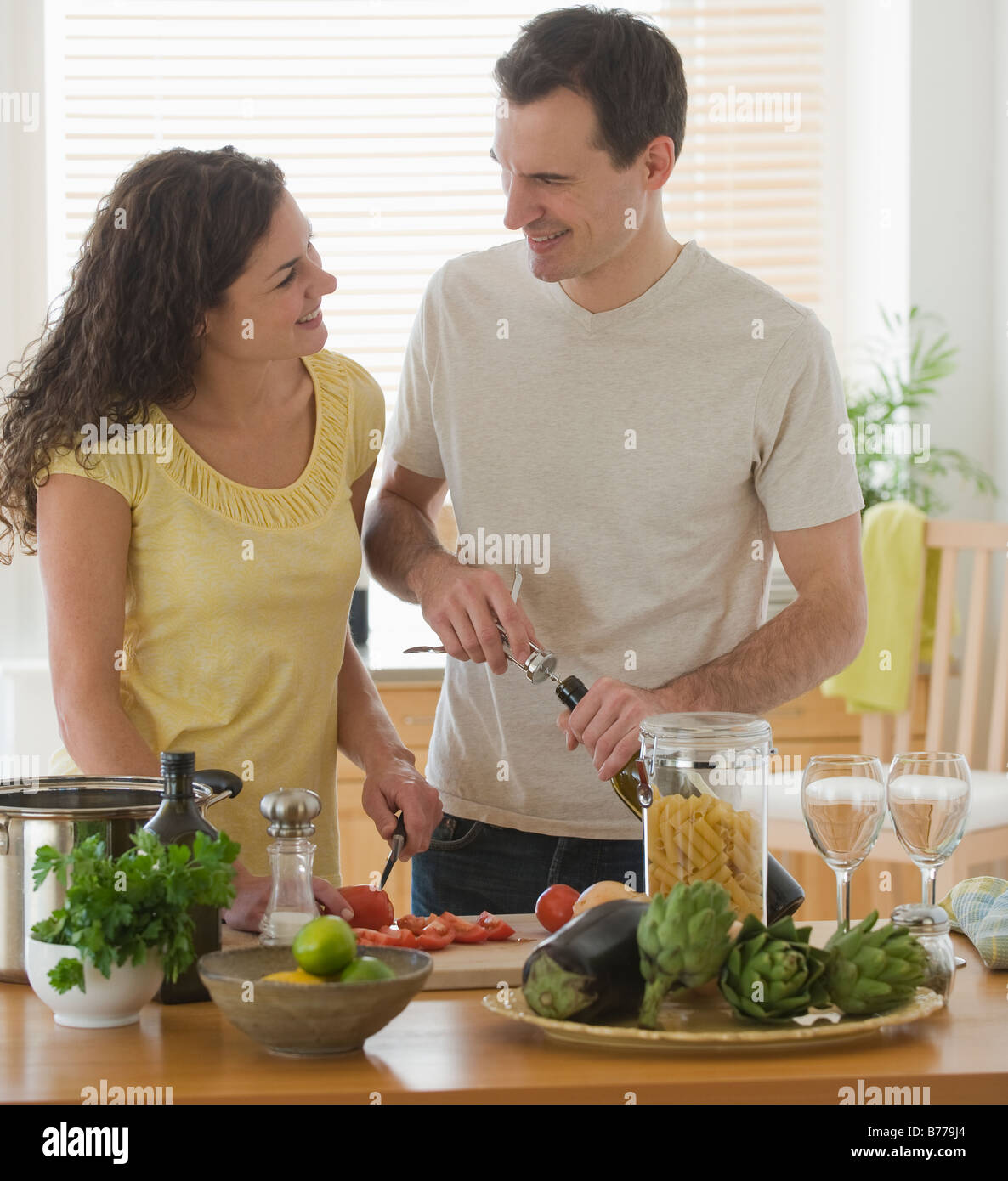Couple preparing meal kitchen Stock Photo - Alamy