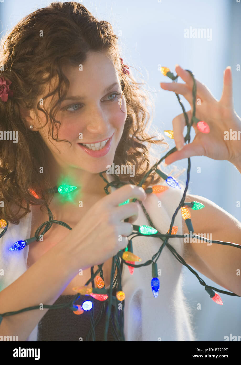 Woman pulling string light hi-res stock photography and images - Alamy