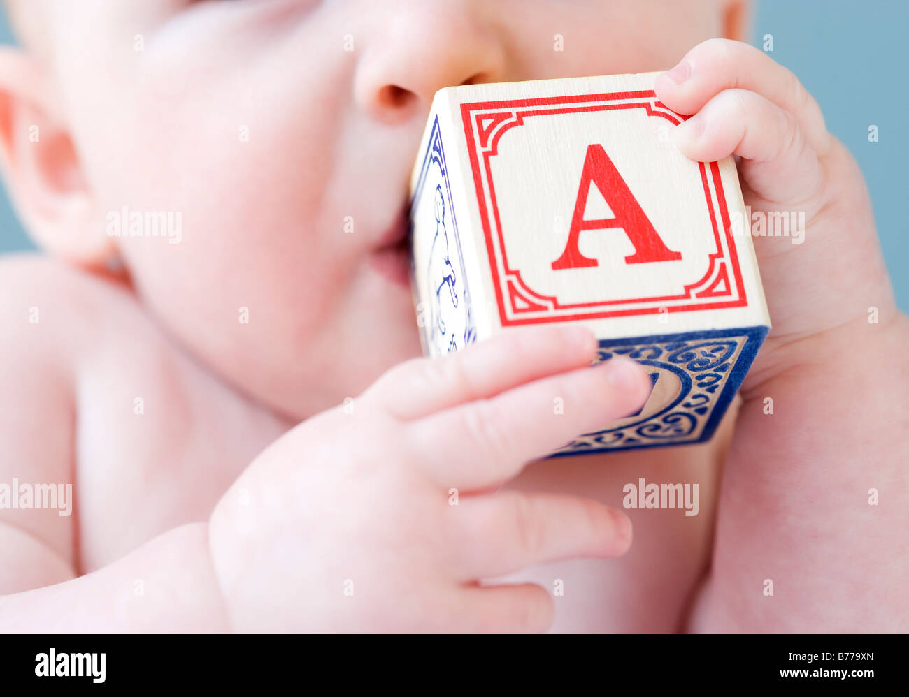 Baby biting on alphabet block hi-res stock photography and images - Alamy