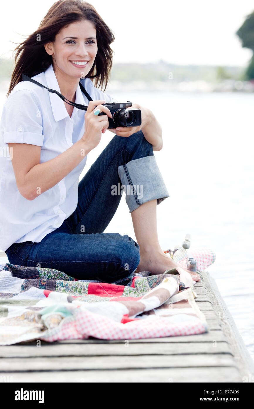 Woman seated on dock hi-res stock photography and images - Alamy