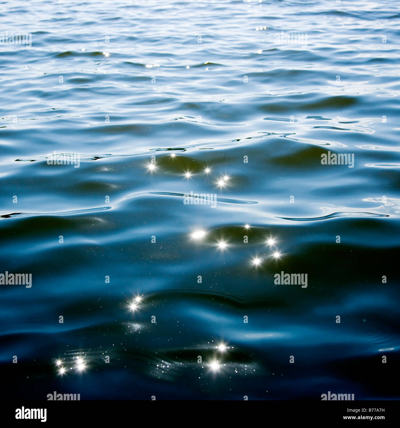 Sun reflecting on lake Stock Photo - Alamy