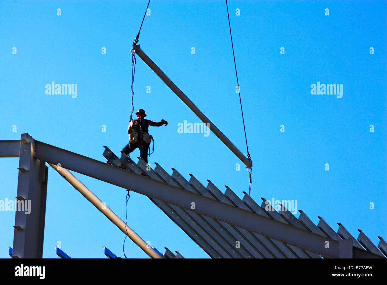 Construction worker standing on roof framing Stock Photo - Alamy