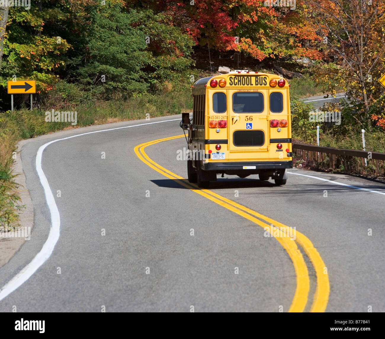 School bus driving down rural road Stock Photo - Alamy