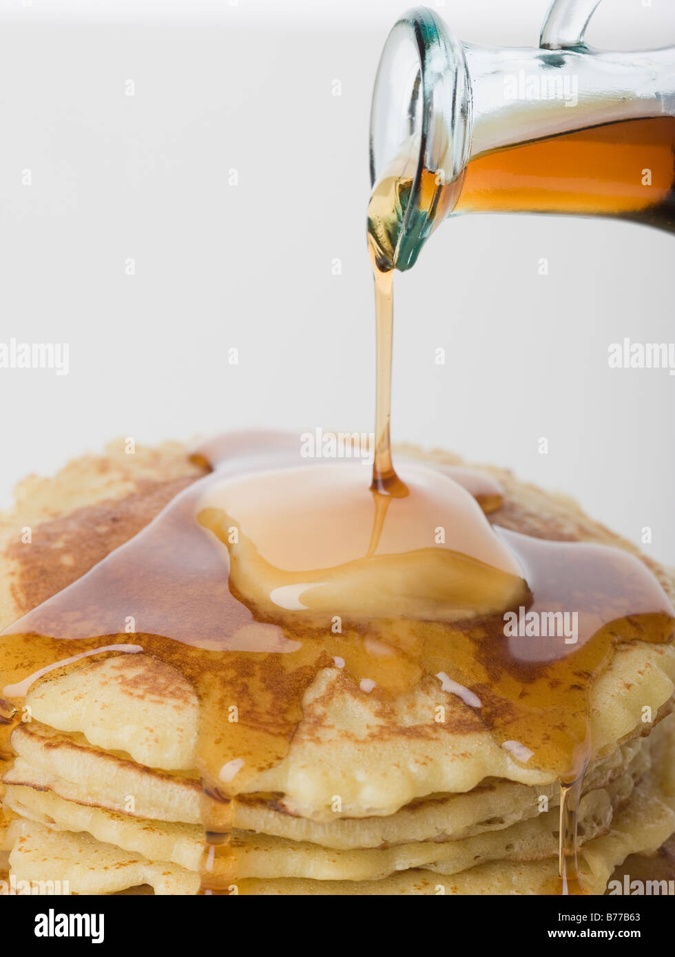 Pouring Syrup On Pancakes