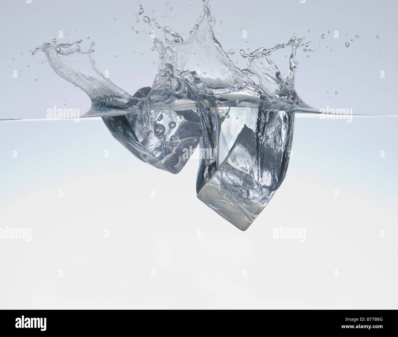 Ice cubes splashing water Stock Photo - Alamy