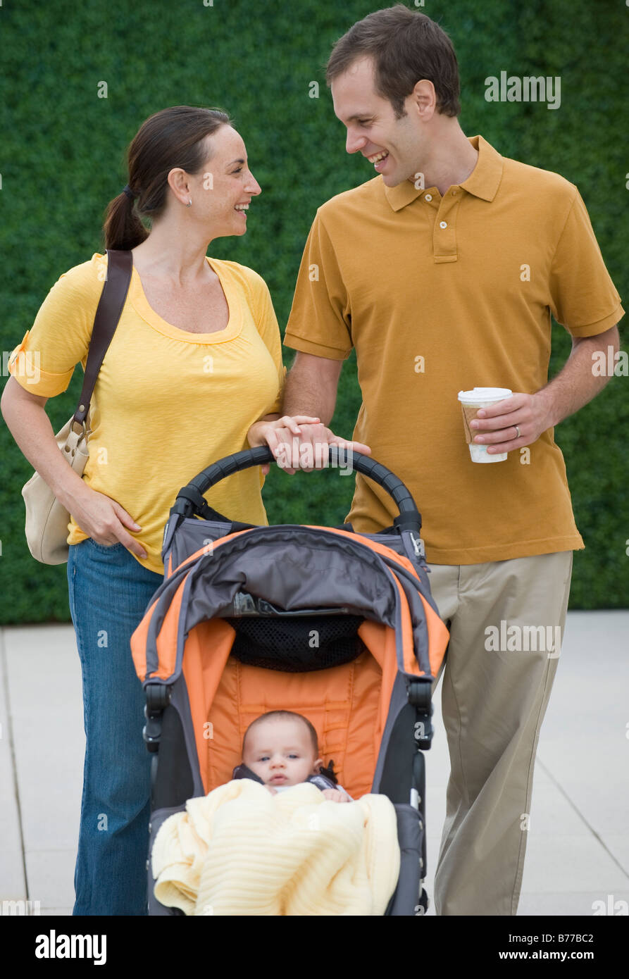 Couple with a baby walking hi-res stock photography and images - Alamy