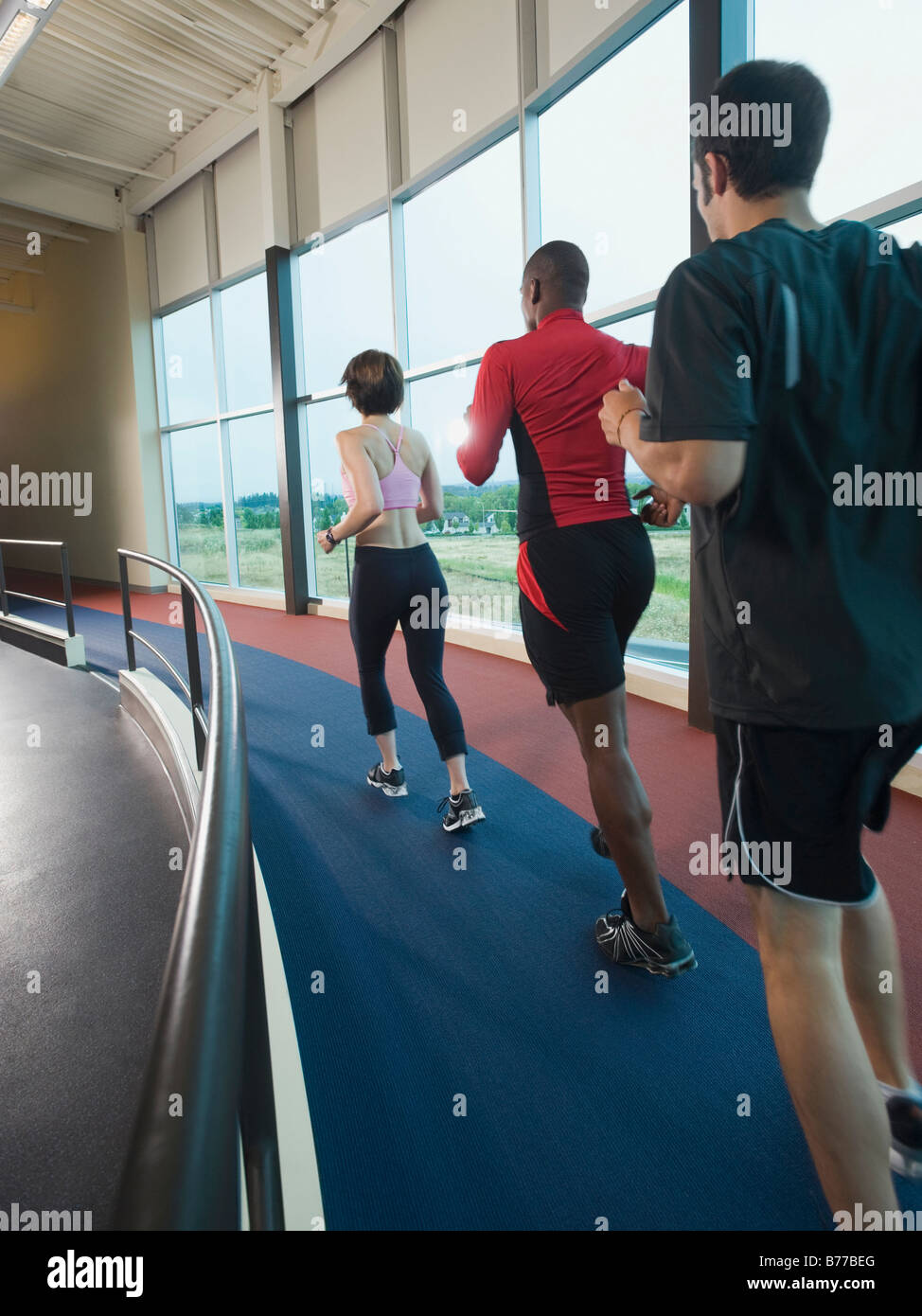 People running on indoor track Stock Photo - Alamy