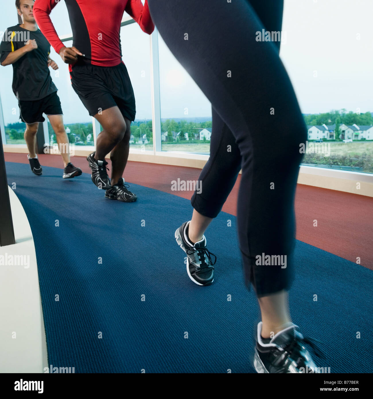 People running on indoor track Stock Photo - Alamy