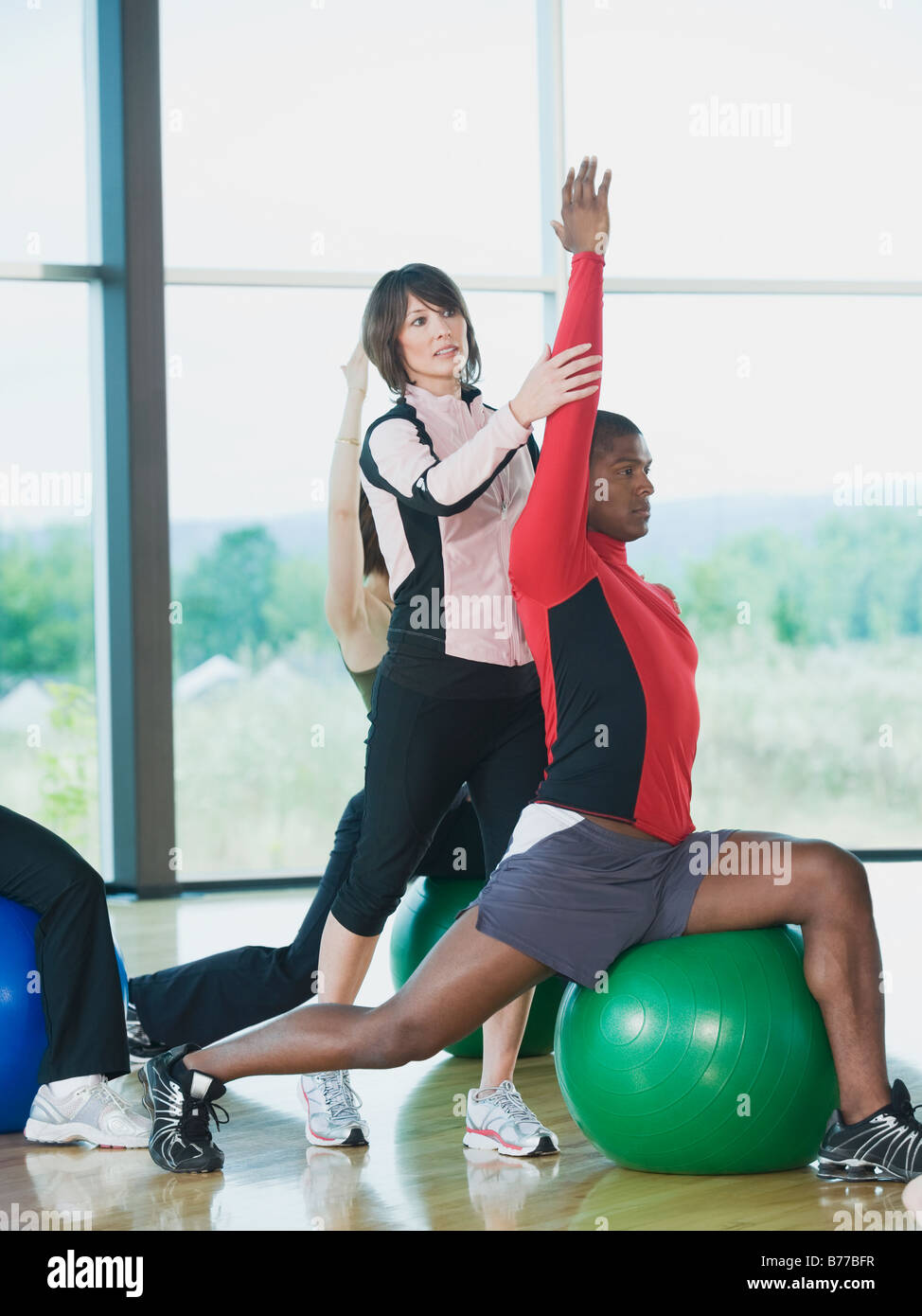 Instructor guiding fitness class Stock Photo - Alamy
