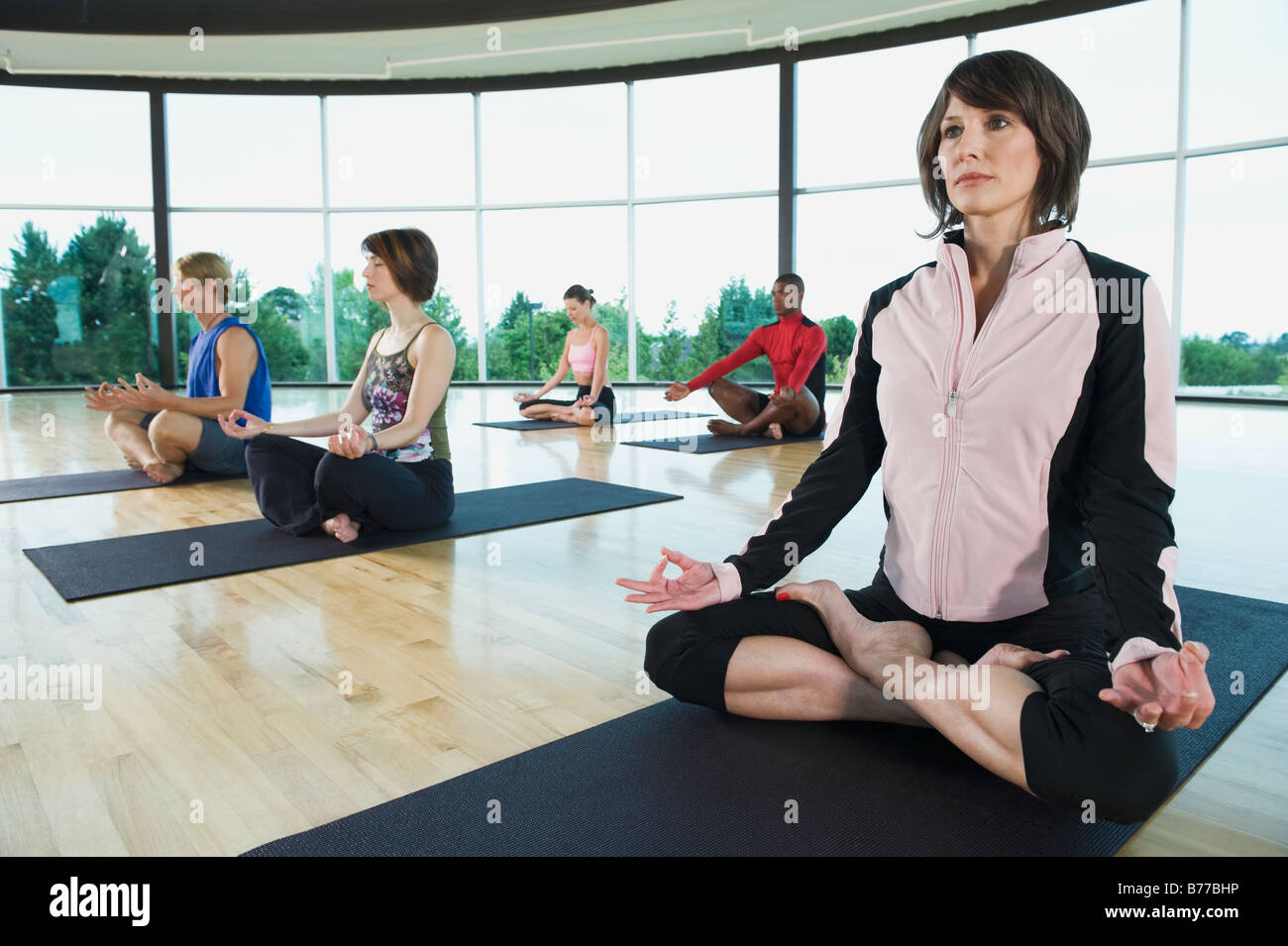 Yoga class lotus pose Stock Photo - Alamy