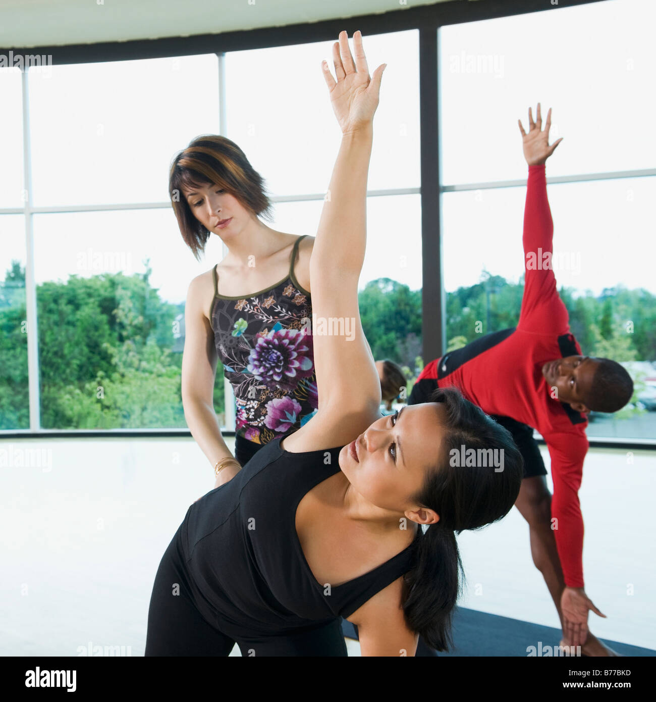 Male yoga instructor helping woman hi-res stock photography and images ...