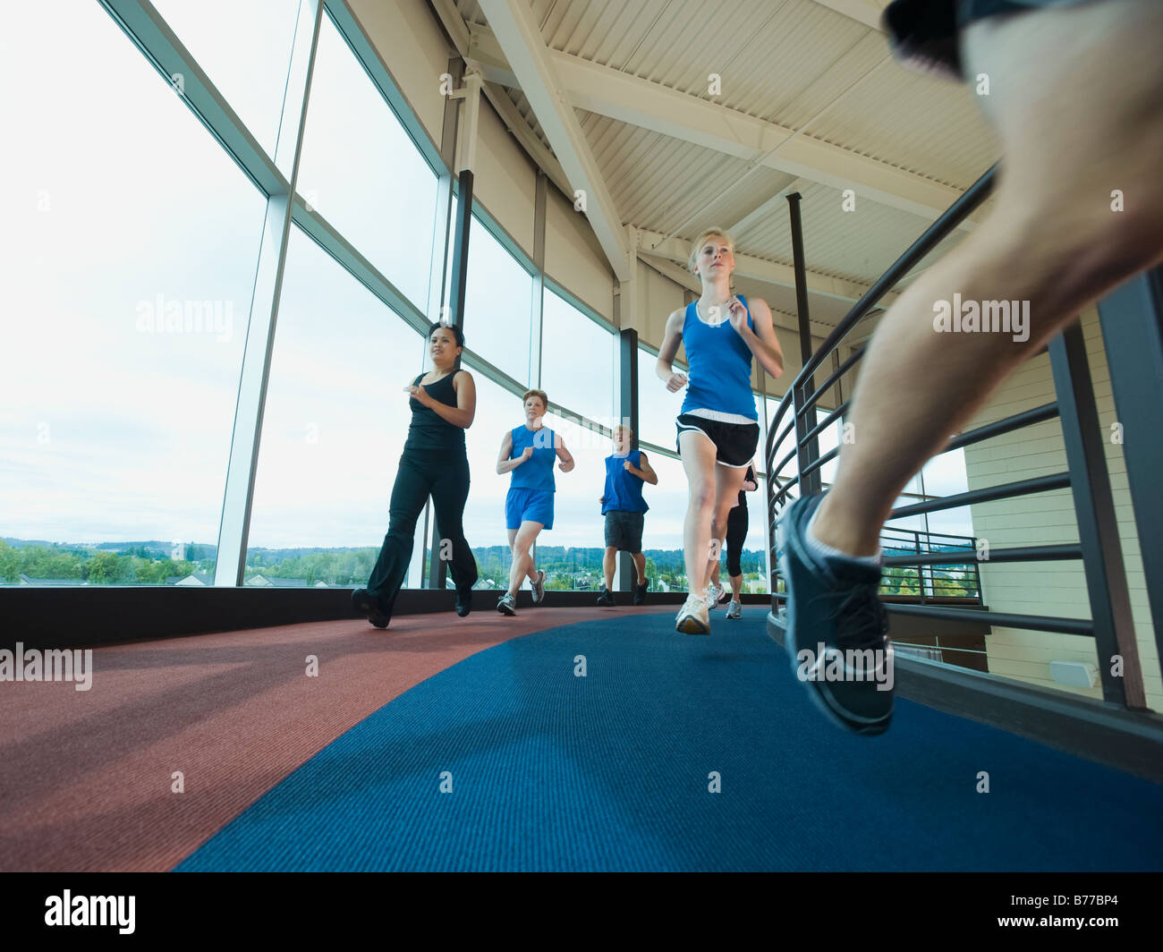 Runners on indoor track Stock Photo - Alamy