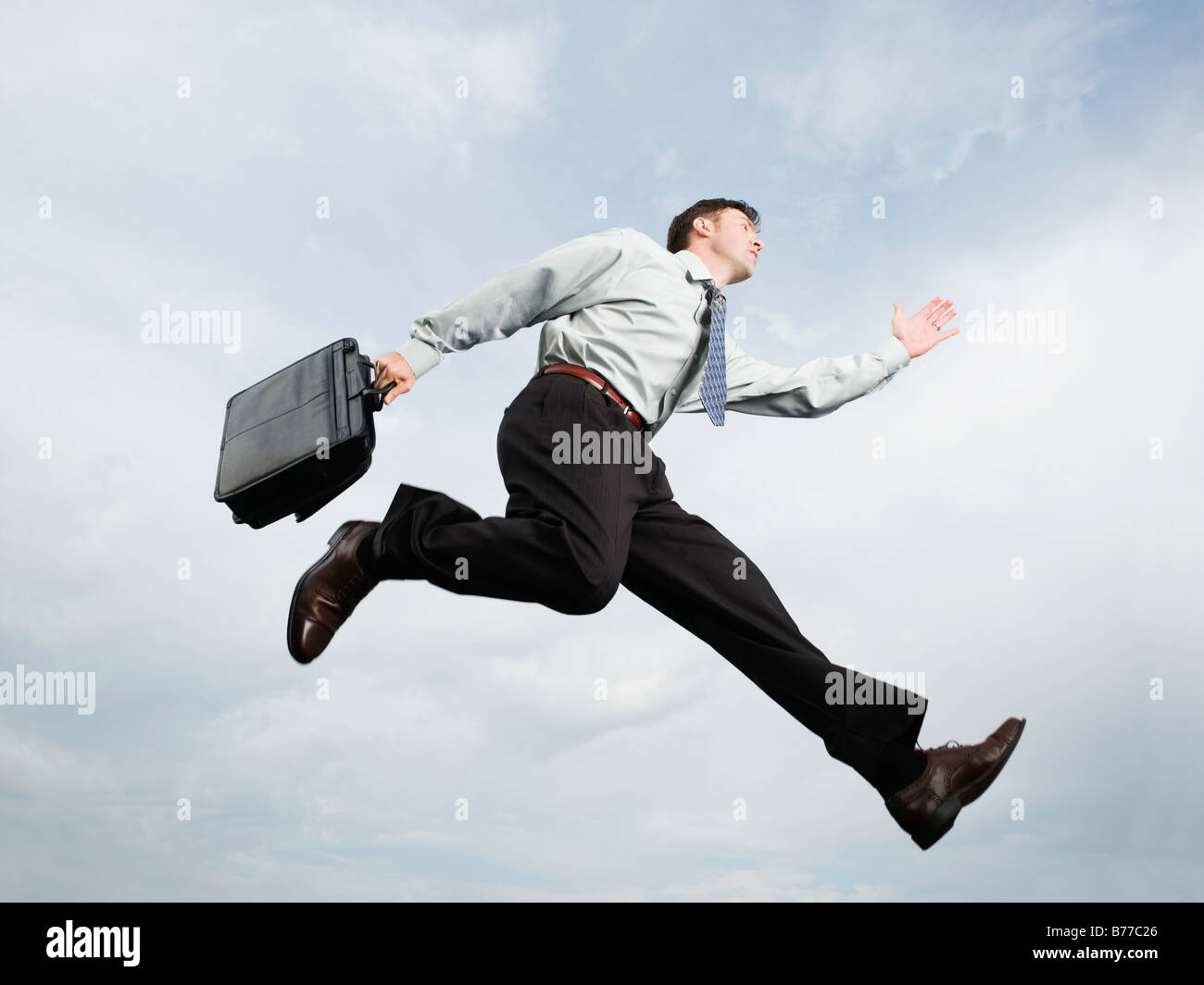 Businessman briefcase jumping mid-air Stock Photo - Alamy Businessman briefcase jumping mid-air Stock Photo - Alamy