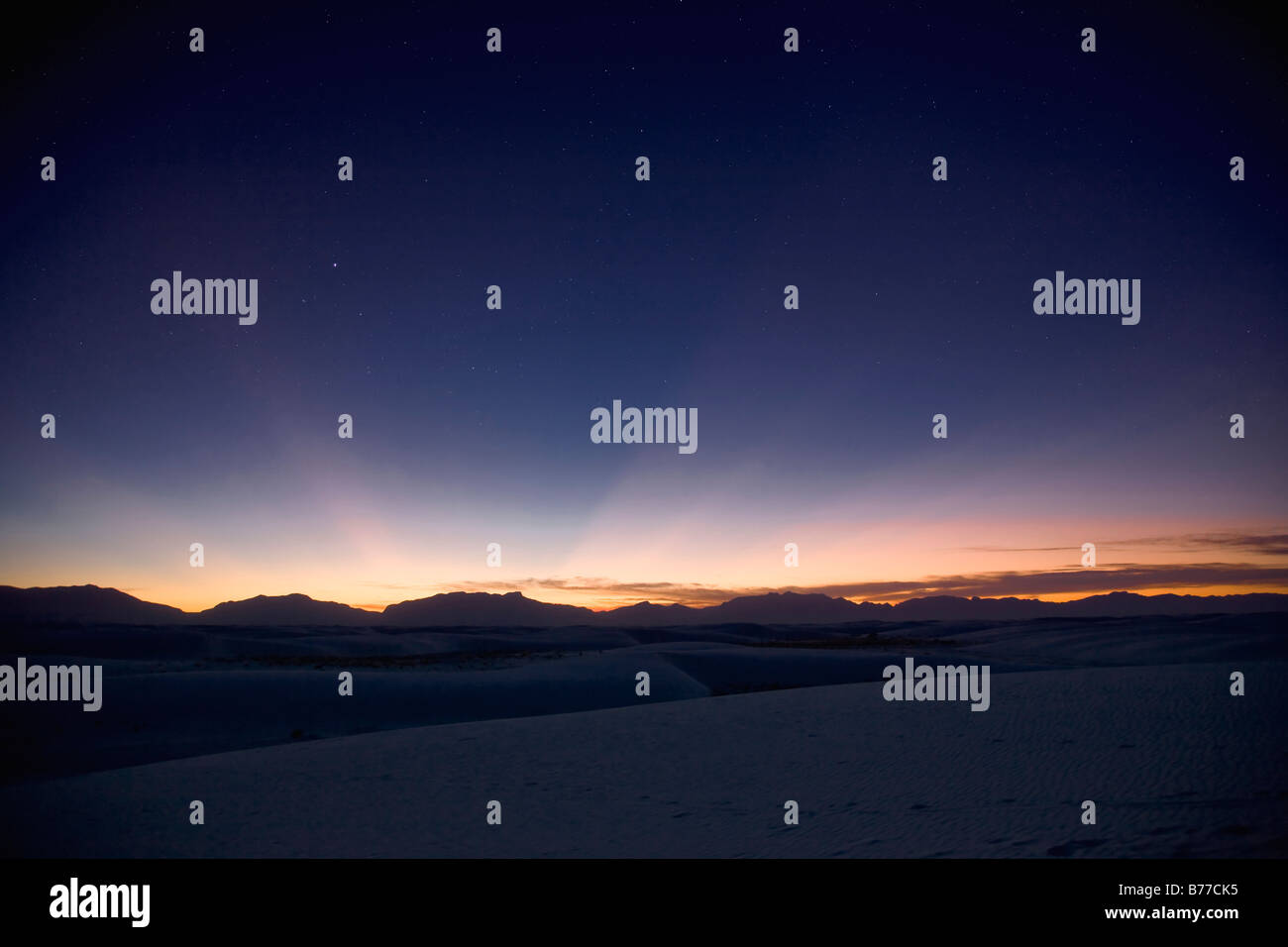 Sunset landscape depicting crepuscular rays at White Sands National ...