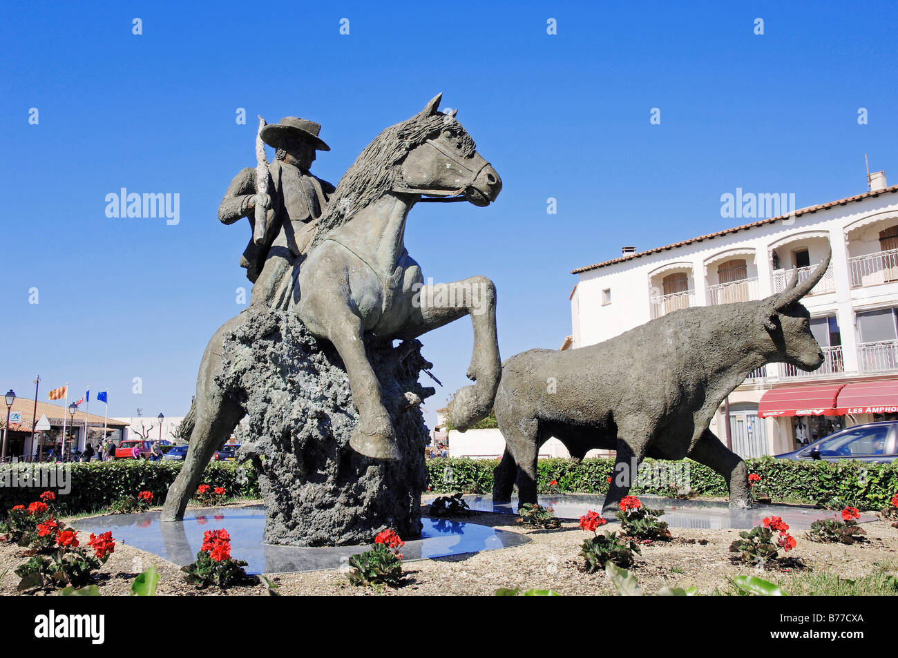 Statue of guardian on Camargue horse beside Camargue bull, Les Saintes ...