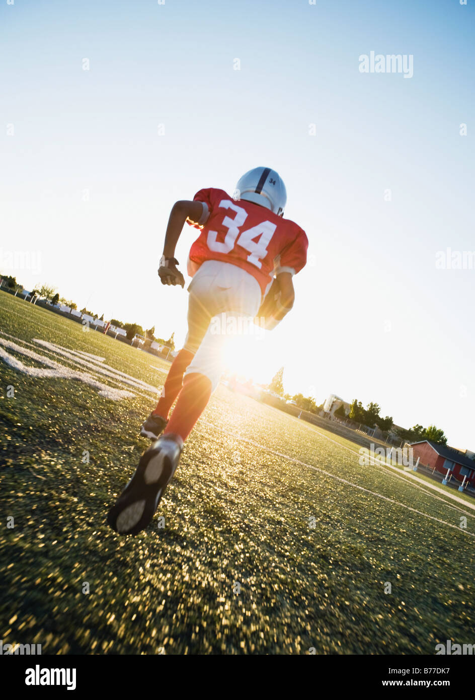 Football player running on field football Stock Photo - Alamy