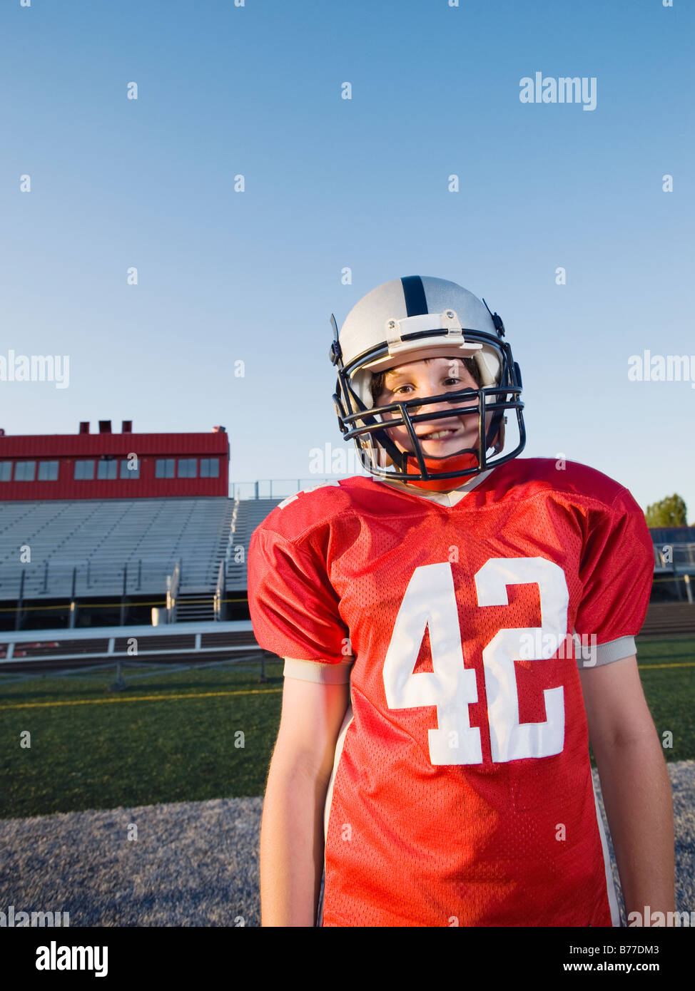 Football player posing on field Stock Photo - Alamy