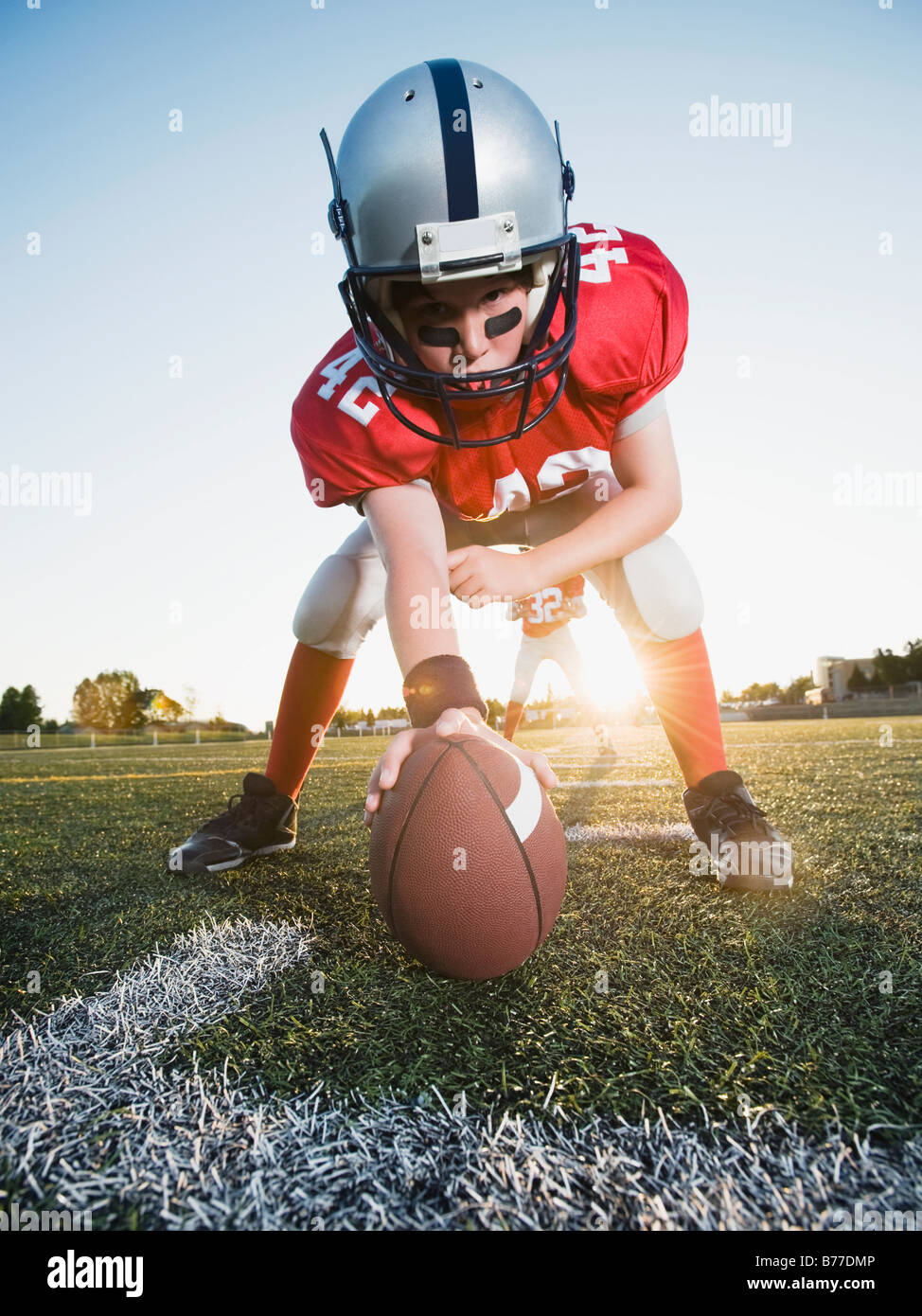 Football center ready to snap football Stock Photo - Alamy