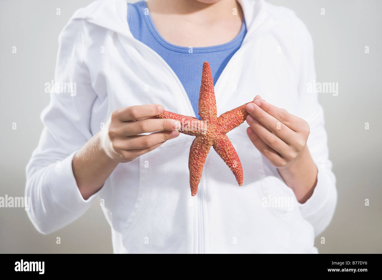 Portrait of girl holding starfish Stock Photo - Alamy