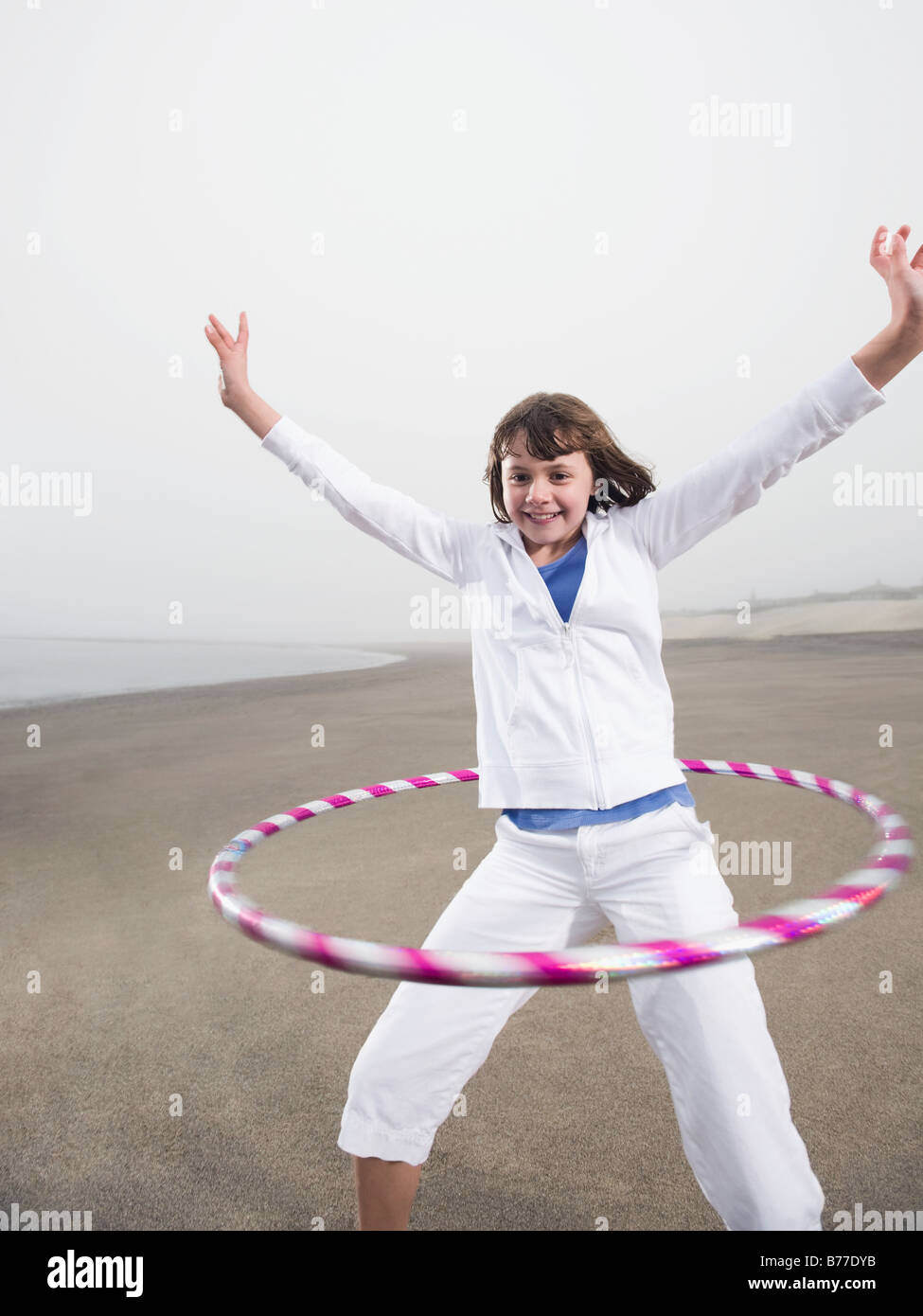 Portrait of girl hula hoop on beach Stock Photo - Alamy