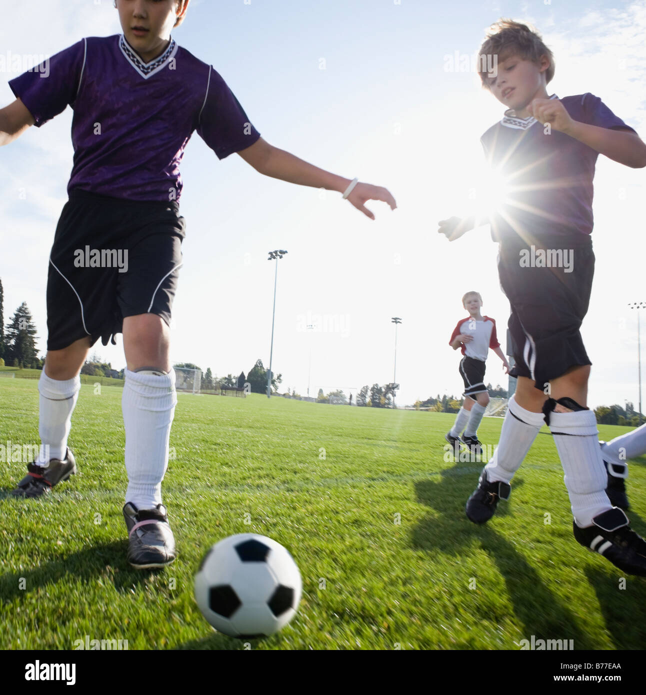 Boys playing competitive soccer Stock Photo - Alamy