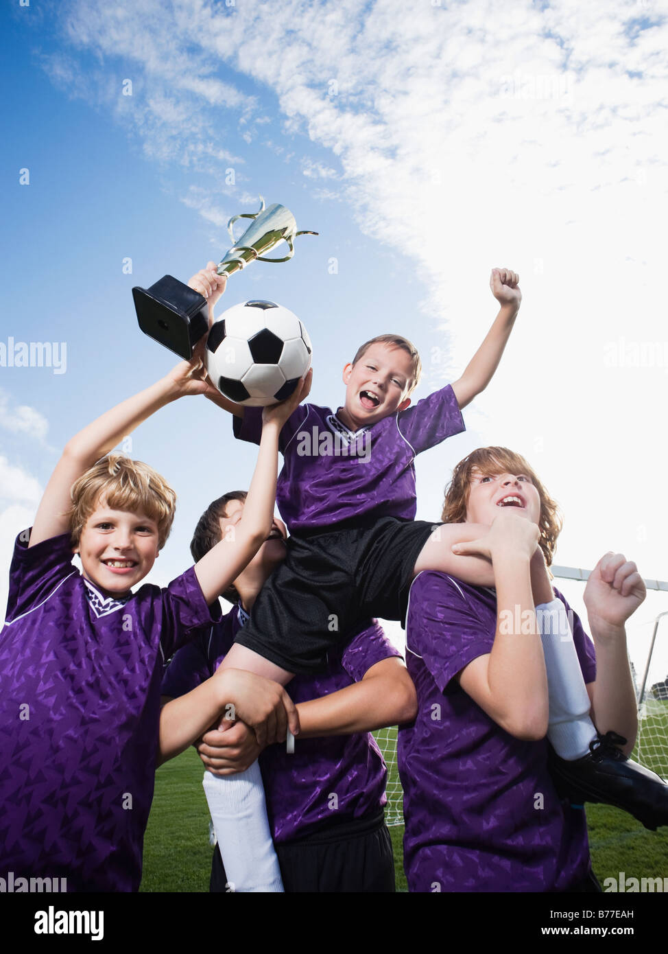 Boys soccer team celebrating trophy Stock Photo - Alamy