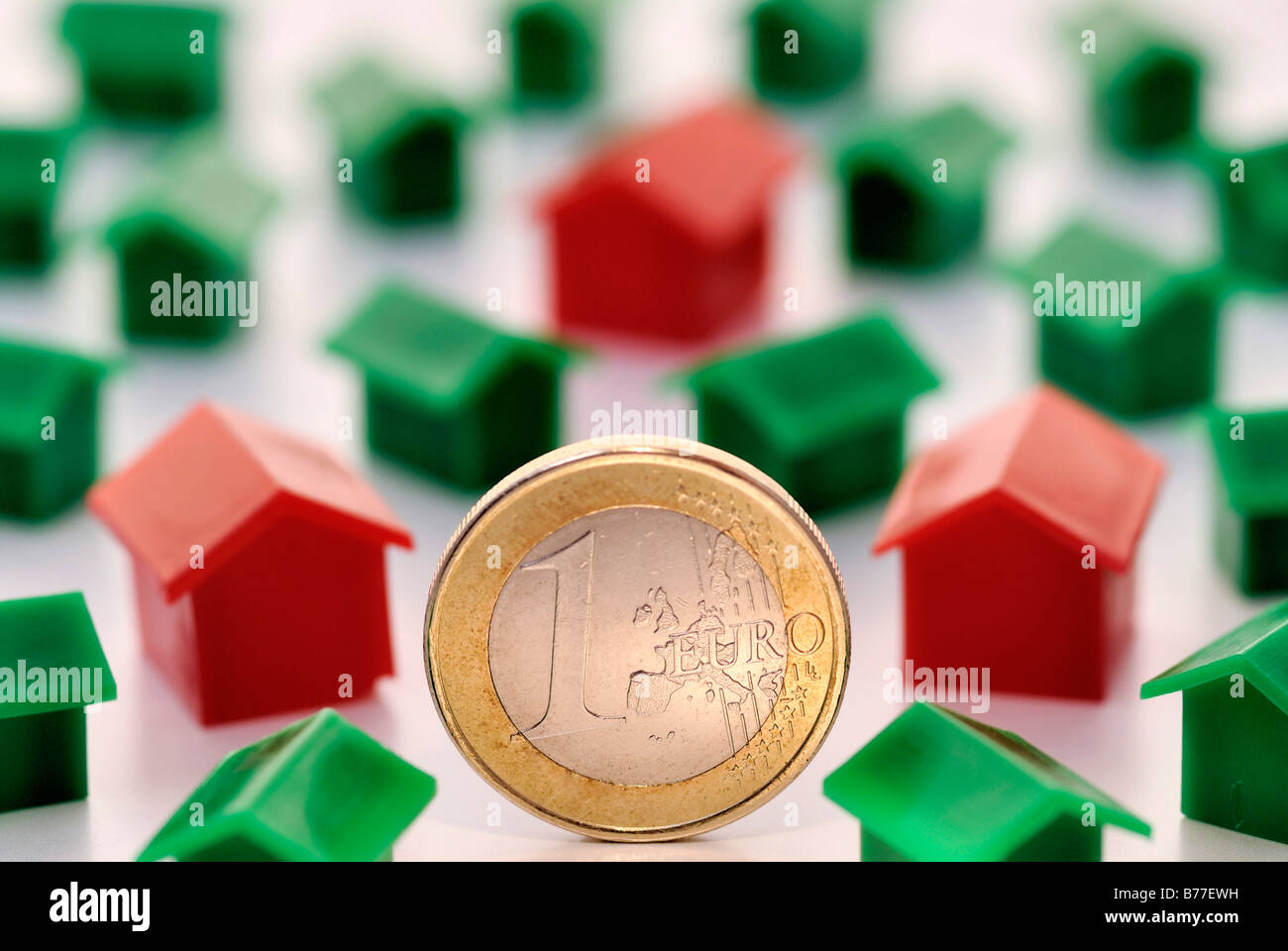 Miniature houses and one euro coin, symbolic of building society ...