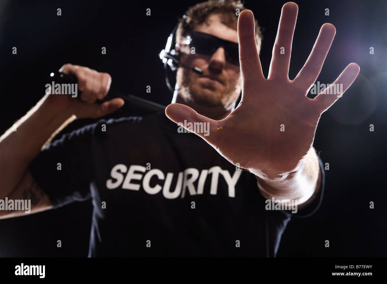 Security guard extending hand Stock Photo - Alamy