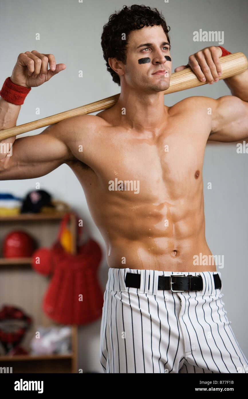 Baseball player bare chest posing locker room Stock Photo - Alamy