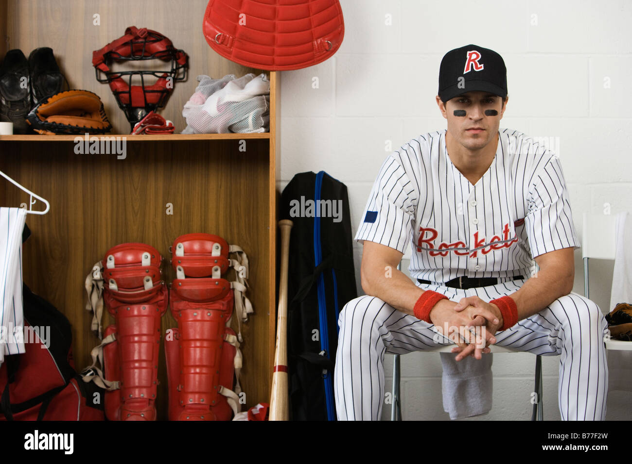 Portrait of baseball player sitting locker room Stock Photo - Alamy