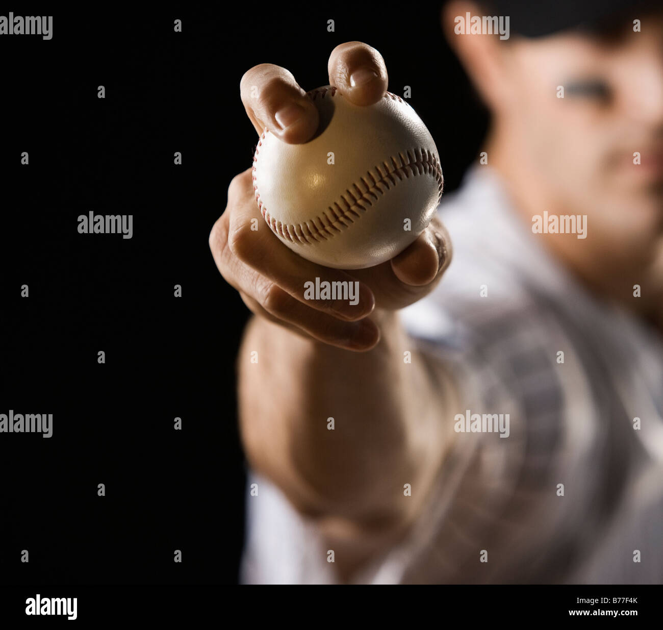 Close up of pitcher holding baseball Stock Photo - Alamy