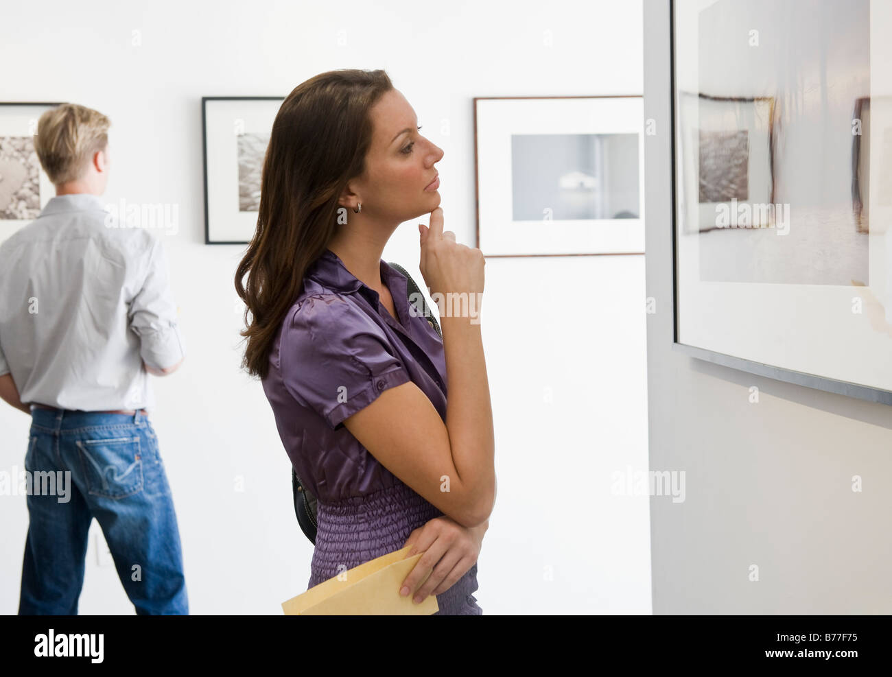 Woman looking picture art gallery Stock Photo - Alamy