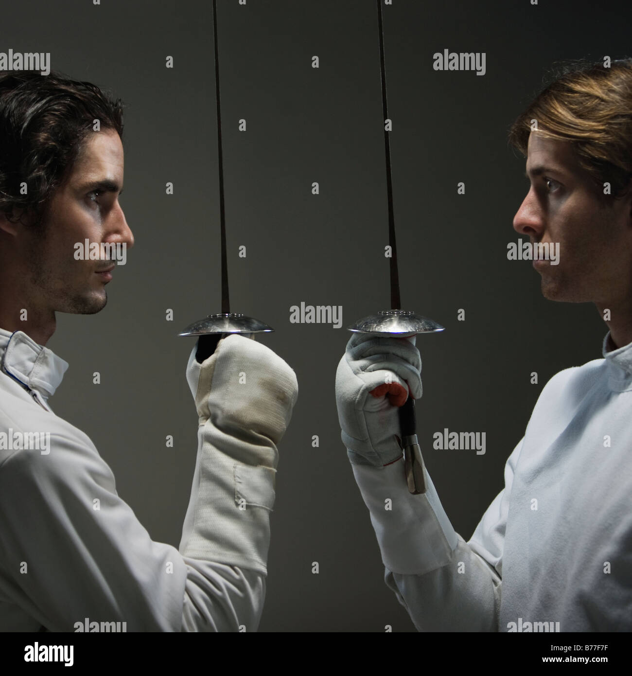 Fencers facing off fencing foils Stock Photo - Alamy