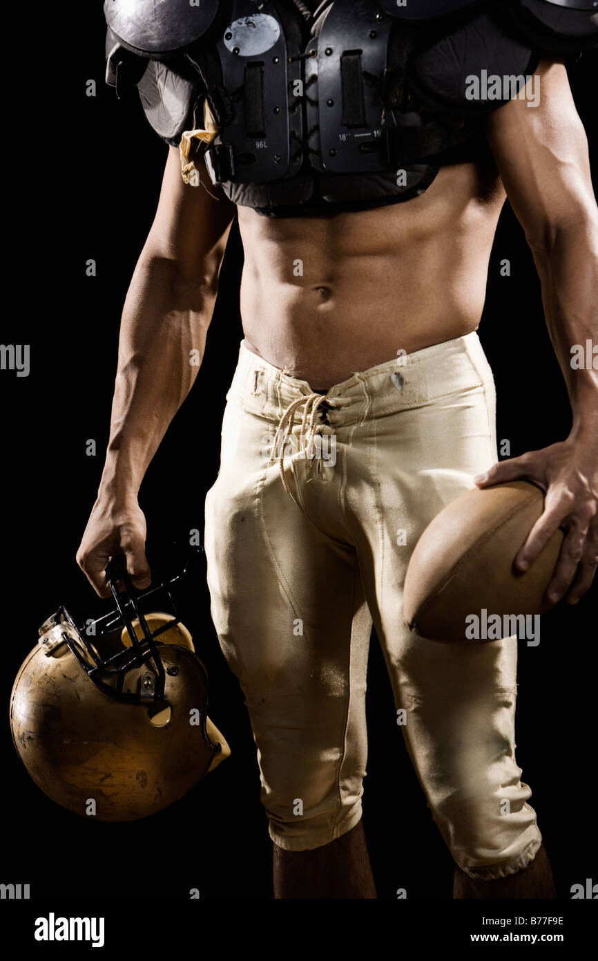 Football player protective gear, football, and helmet Stock Photo - Alamy