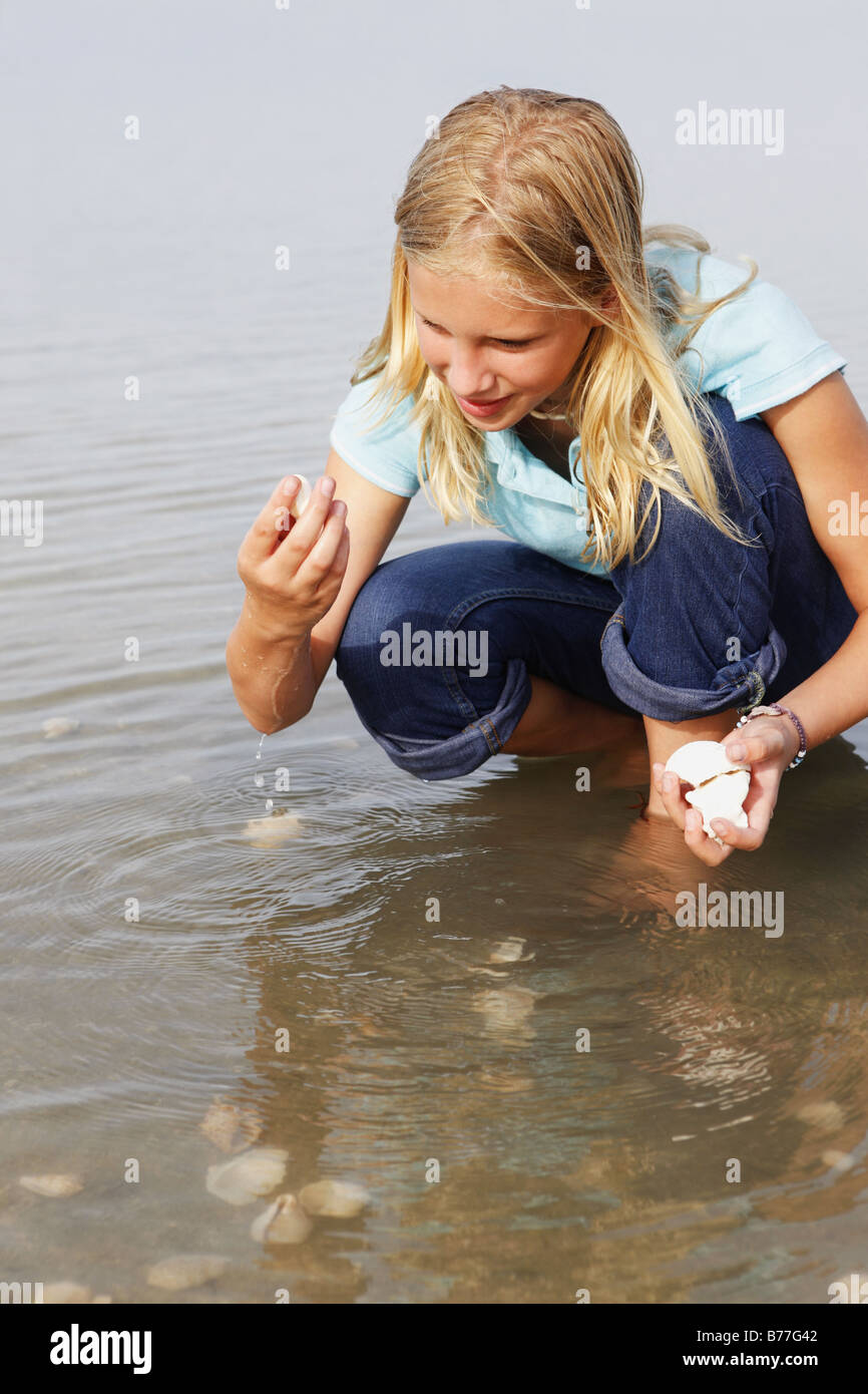 Girl Holding Seashells High Resolution Stock Photography and Images - Alamy