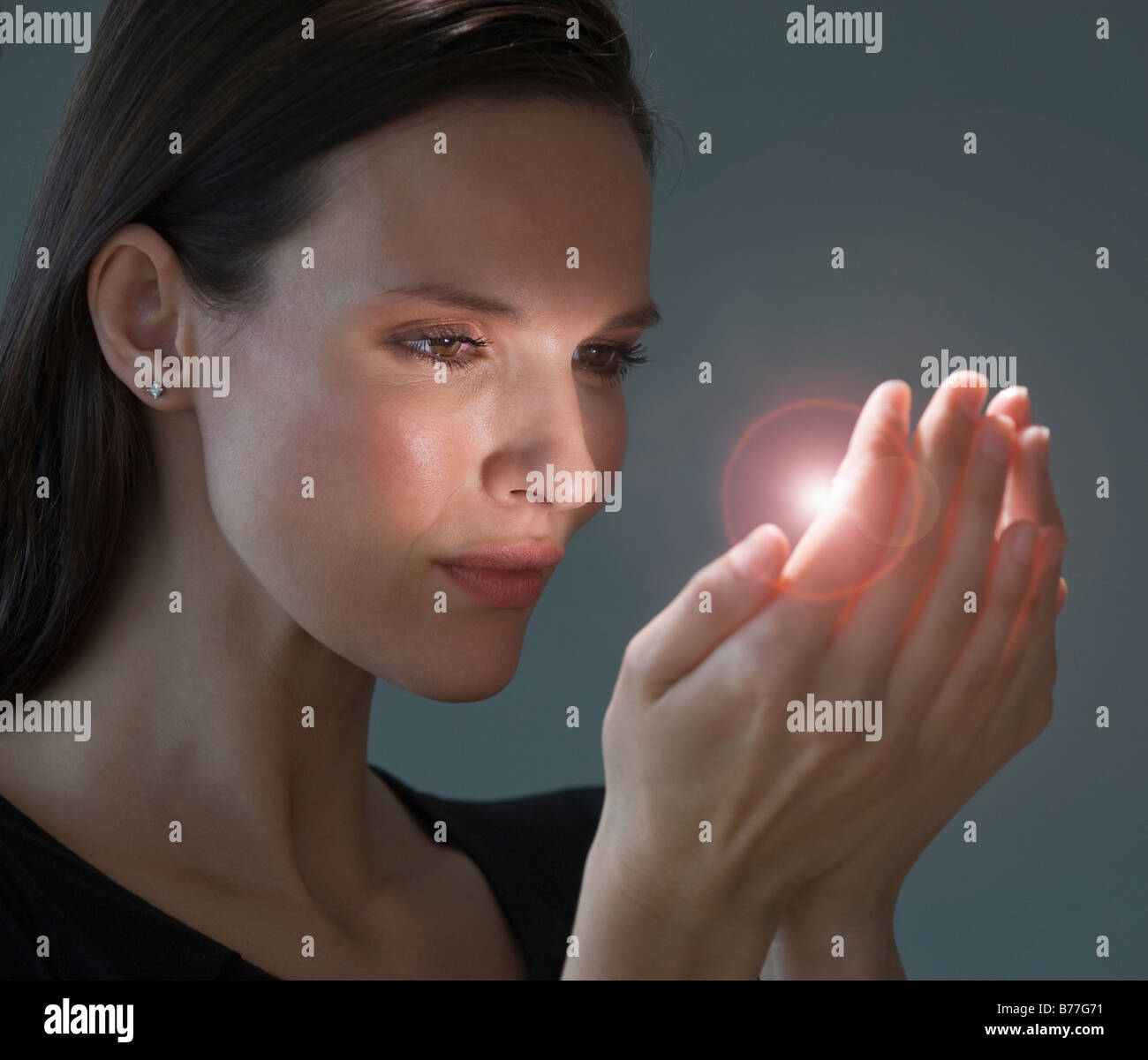 Light shining from woman’s hands Stock Photo - Alamy
