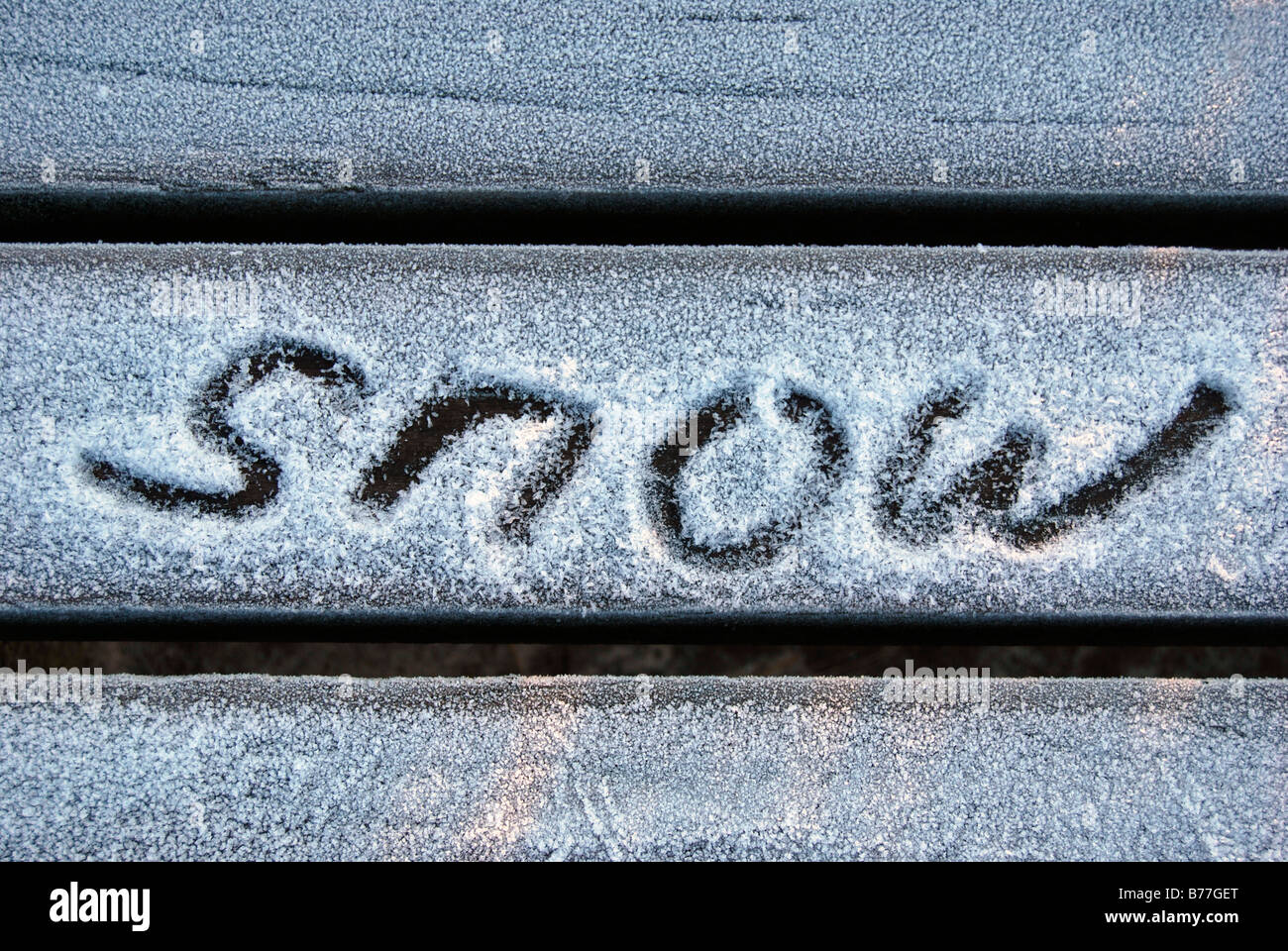 Snow written on a bench covered with frost Stock Photo - Alamy