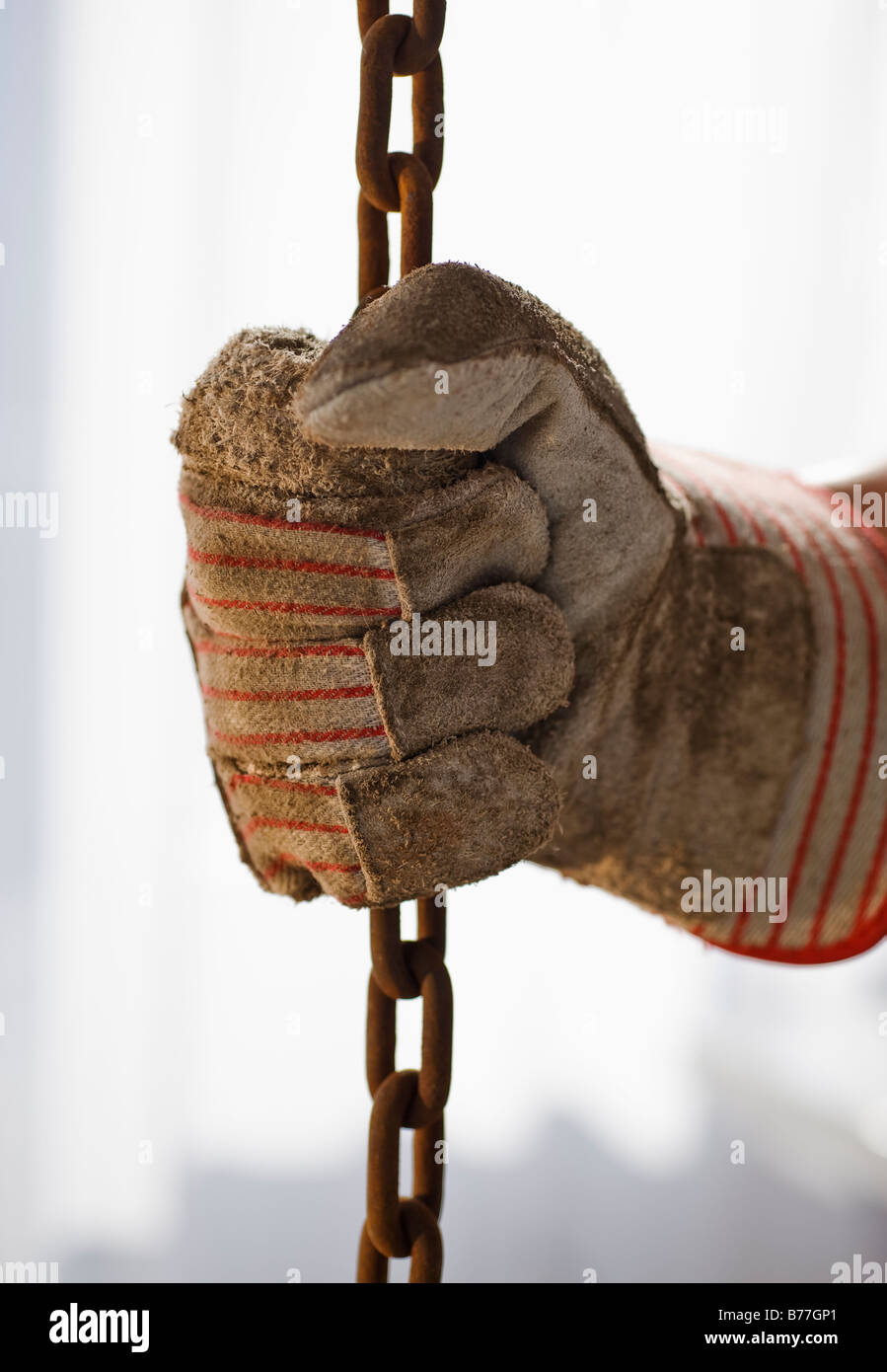 Close up of gloved hand holding chain Stock Photo - Alamy