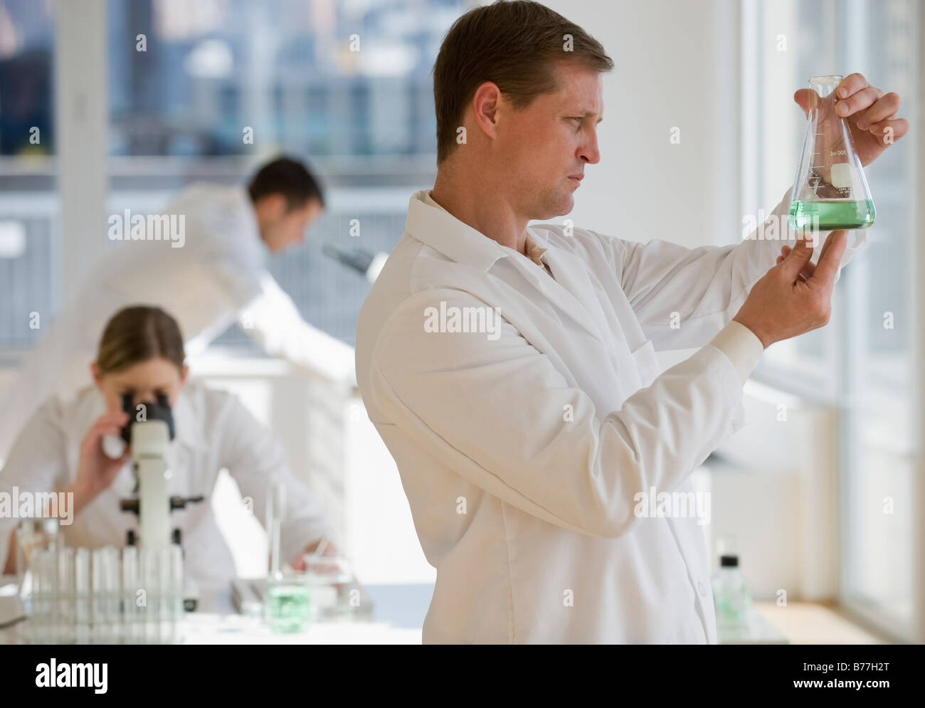 Scientist examining liquid pharmaceutical laboratory Stock Photo - Alamy