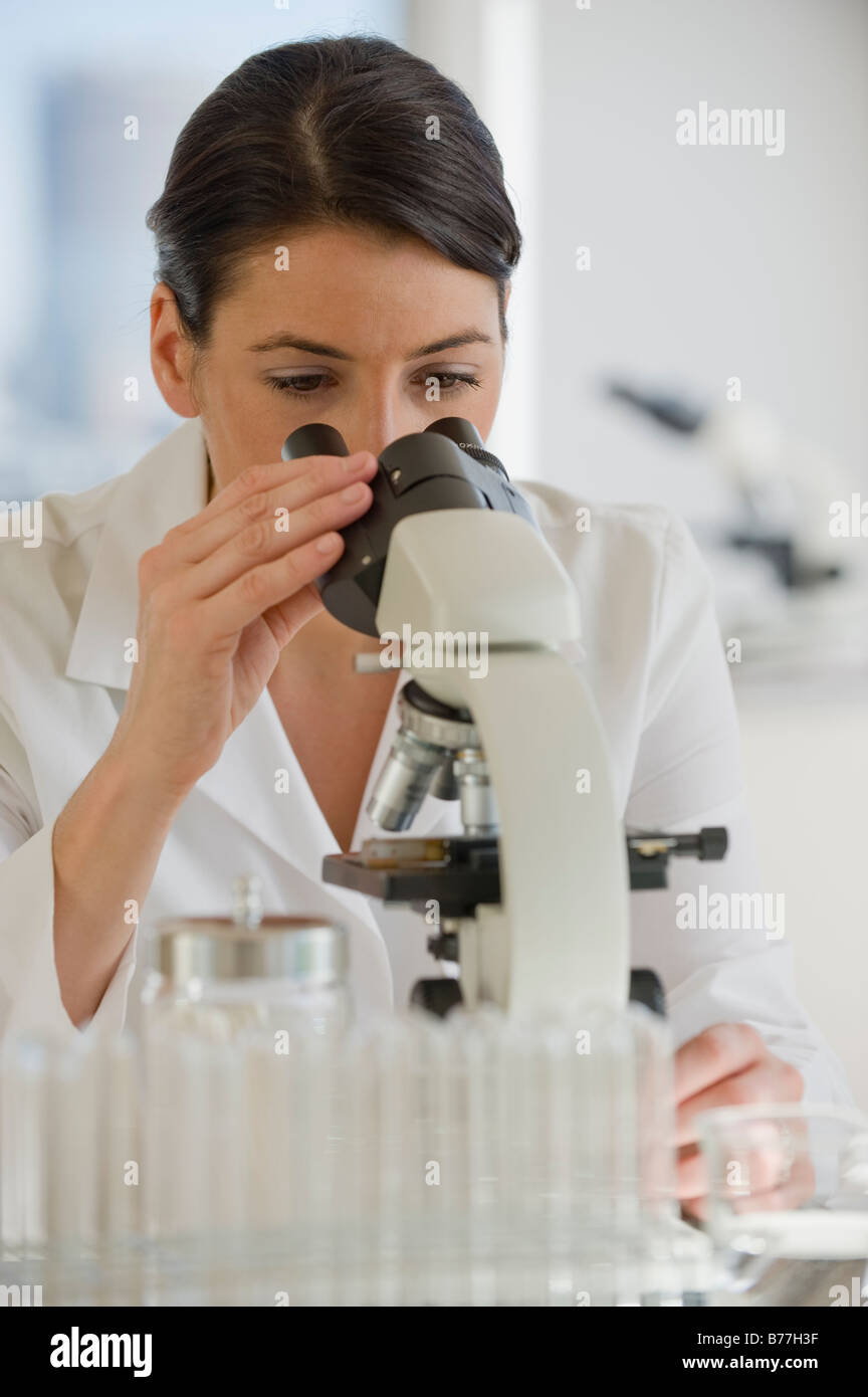 Scientist using microscope pharmaceutical laboratory Stock Photo - Alamy